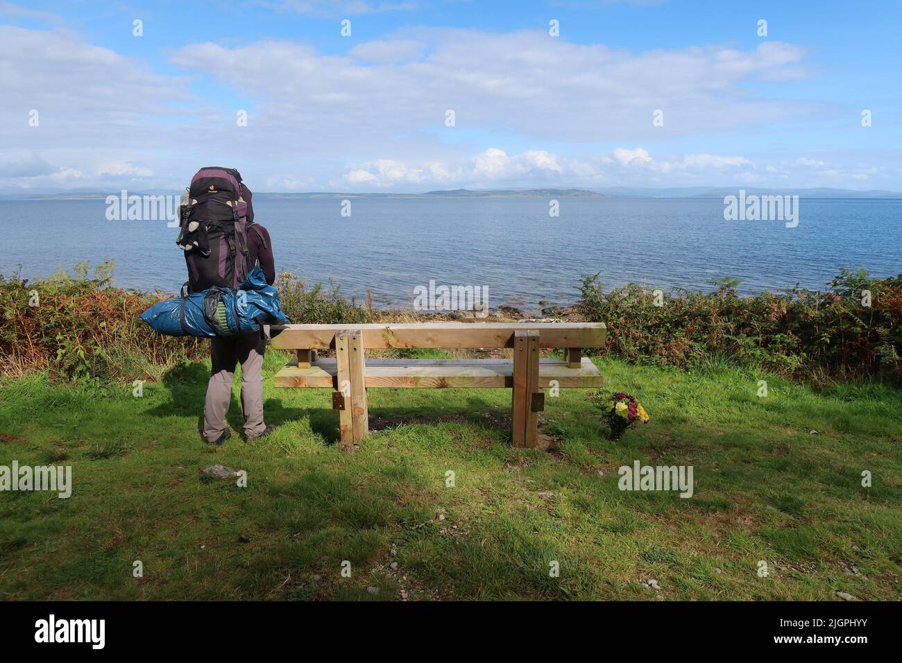 Solo Backpacker hiking with a big backpack. Arran Coastal Way. Isle of ...
