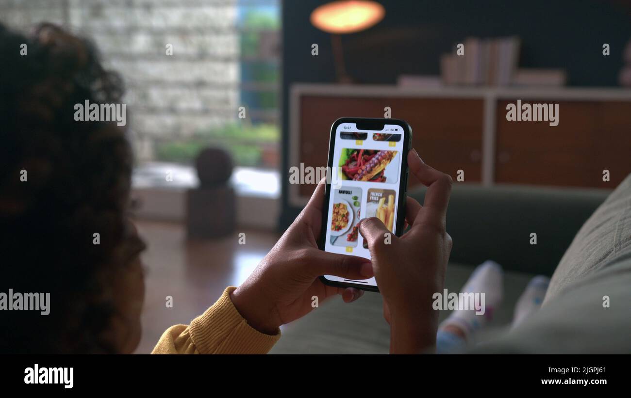 Hand closeup browsing food online store on cellphone app. Person ...