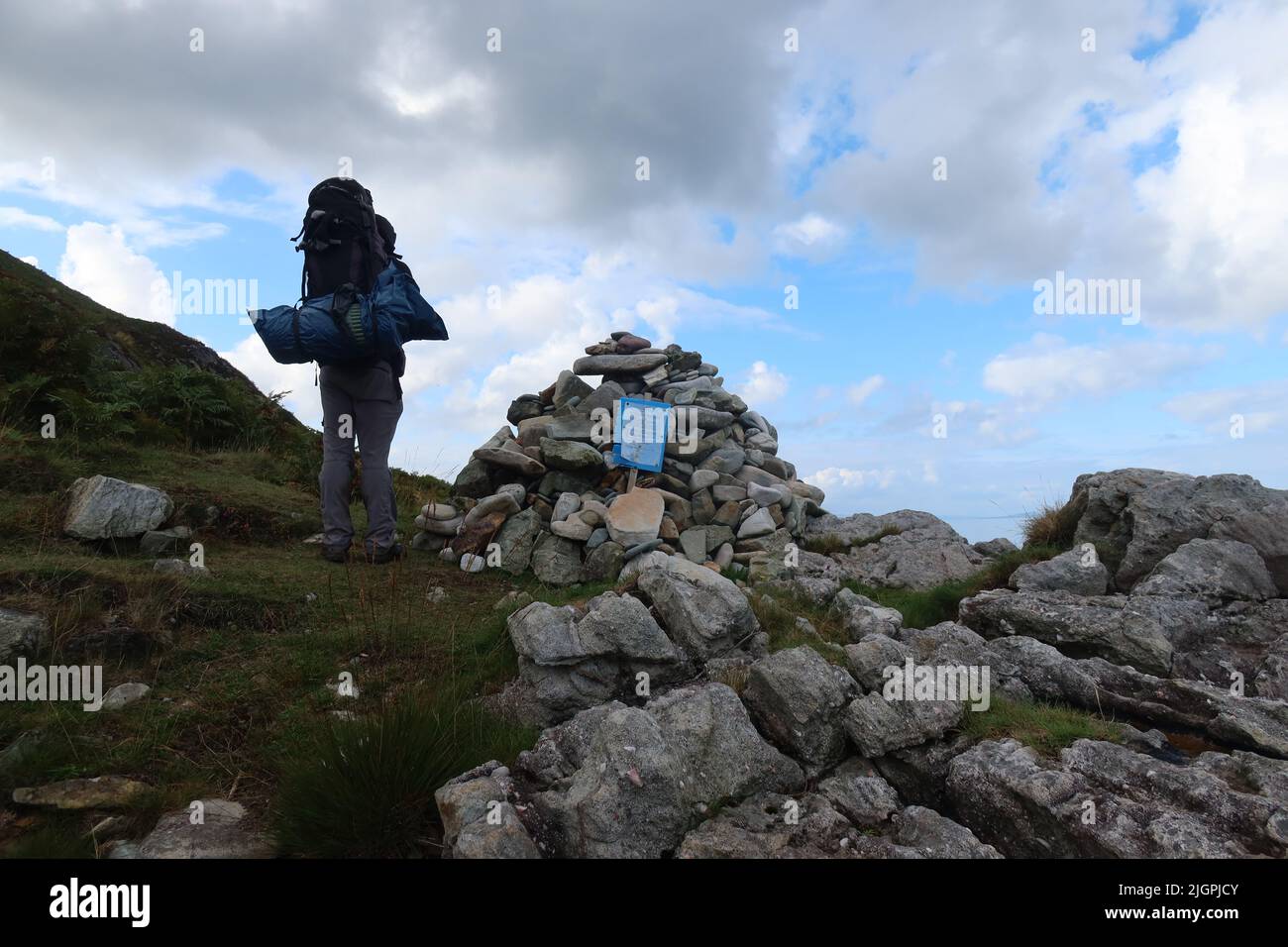 Solo Backpacker hiking with a big backpack. Arran Coastal Way. Isle of ...