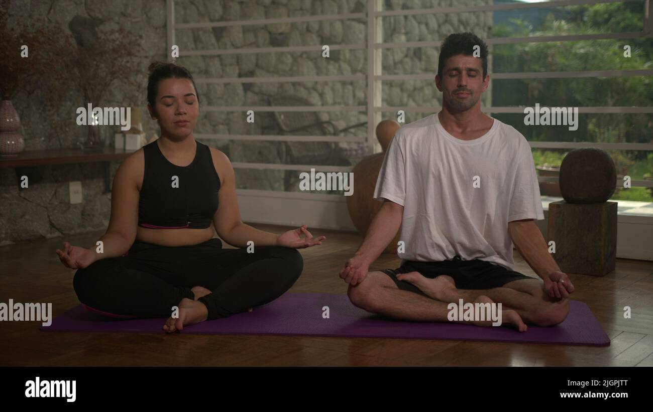 Calm couple in meditation. Male and female people in mindfulness ...