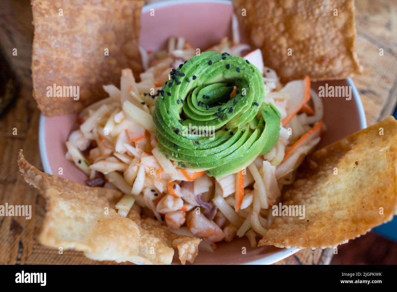 Mexican style ceviche bowl with raw prawns, crab sticks, avocado and ...