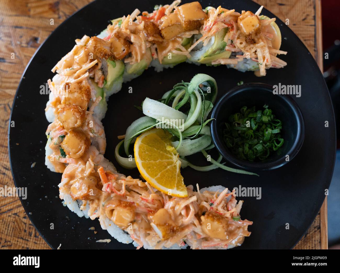 Sushi roll plate with breaded prawn and sauce view from top ...