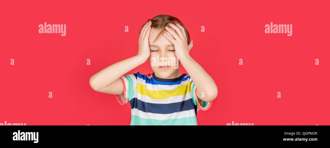 Portrait of a sad boy holding his head with his hand, isolated on the ...