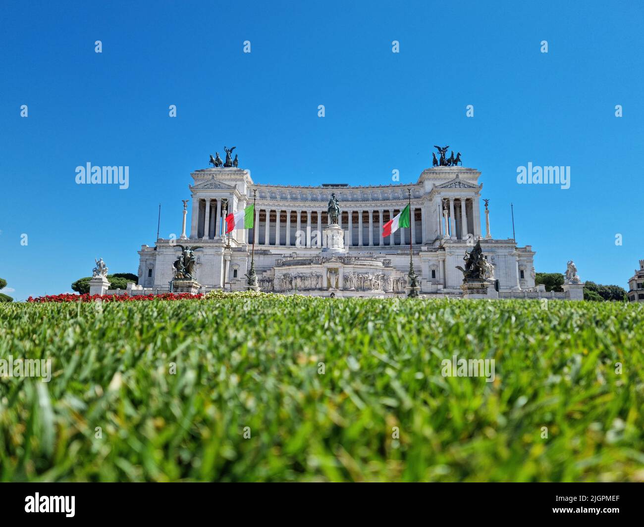 Altar of the fatherland, a famous Italian national monument. Green lawn ...