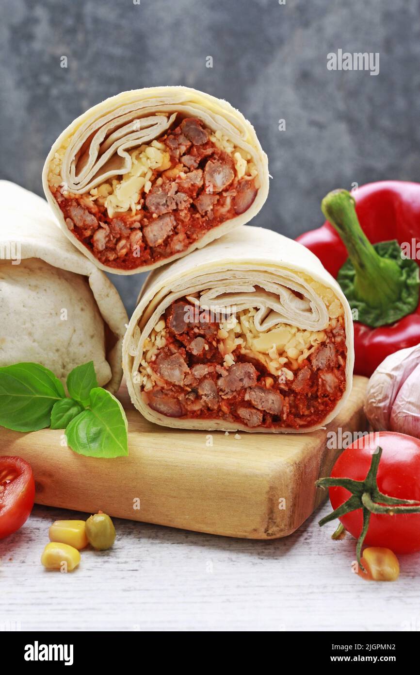 A burrito - mexican dish that consists of a flour tortilla with various ...