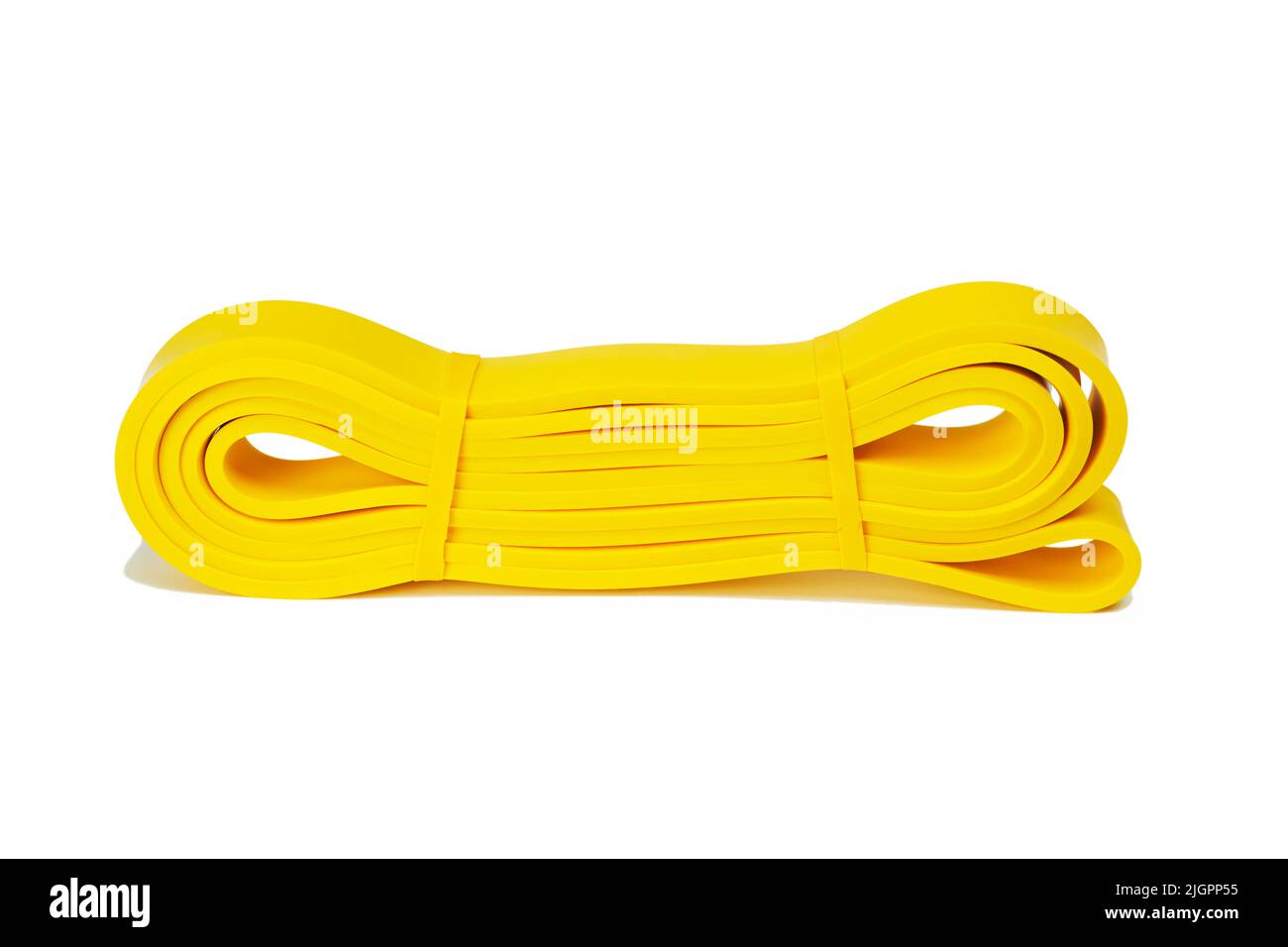 a yellow resistance band, rolled up and tied up, on a white background ...