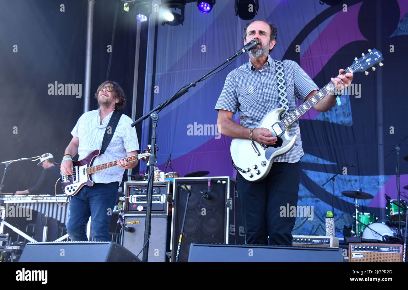 Moe band members are shown performing on stage during a “live” concert ...