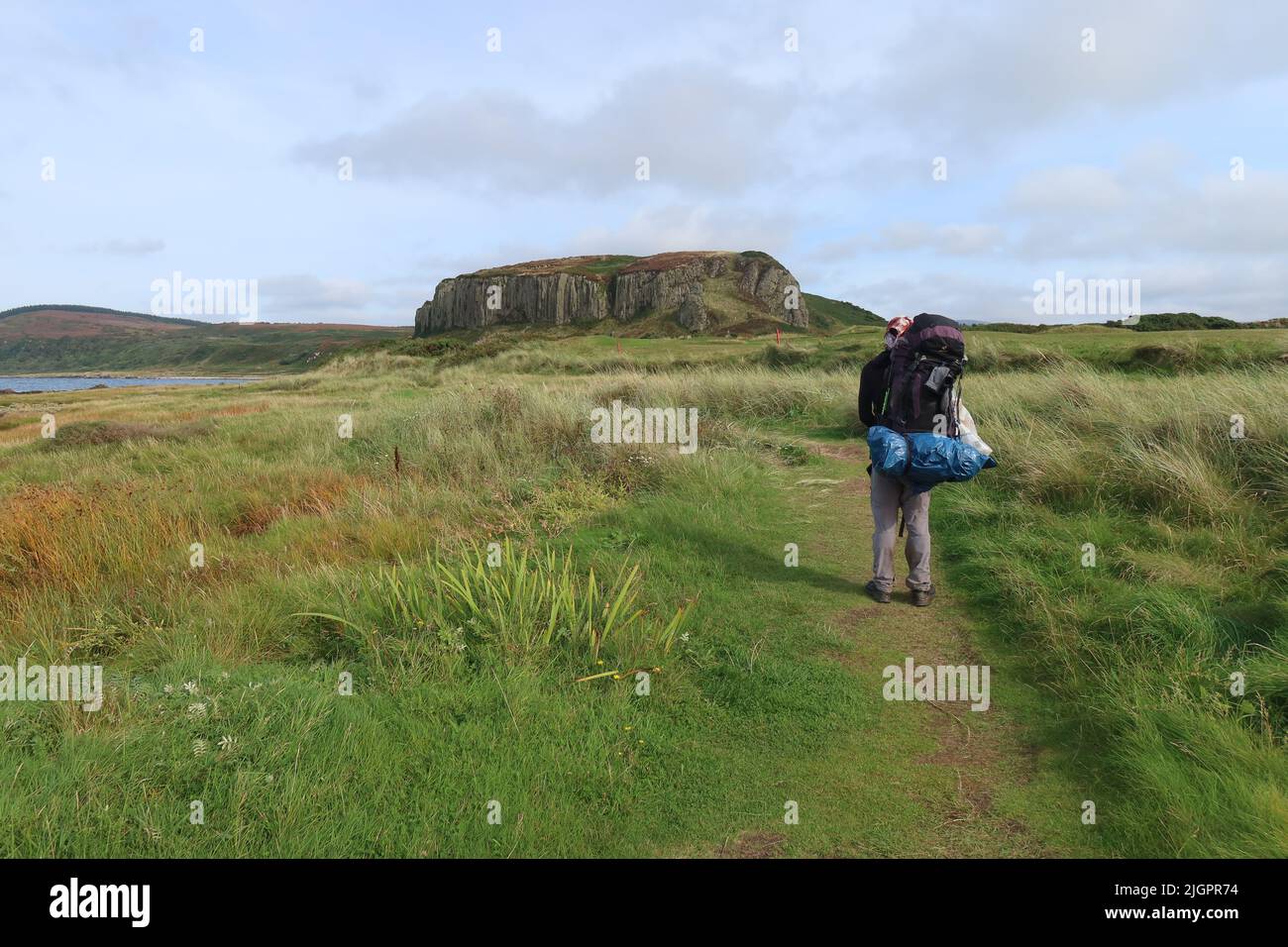 Solo Backpacker hiking with a big backpack. Arran Coastal Way. Isle of ...