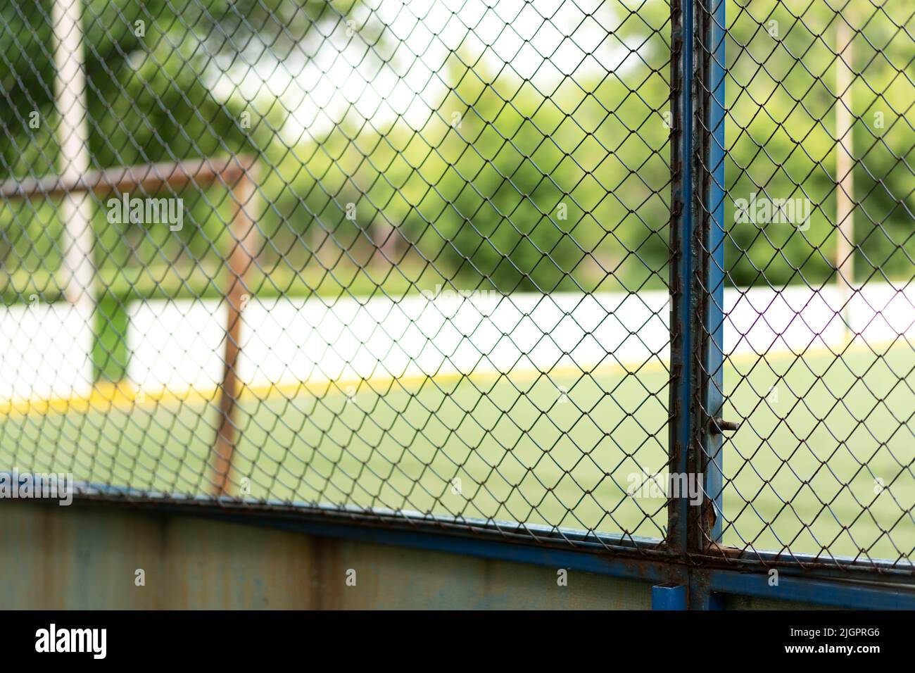 Rusty grating around the football field opposite the rusty gate Stock ...