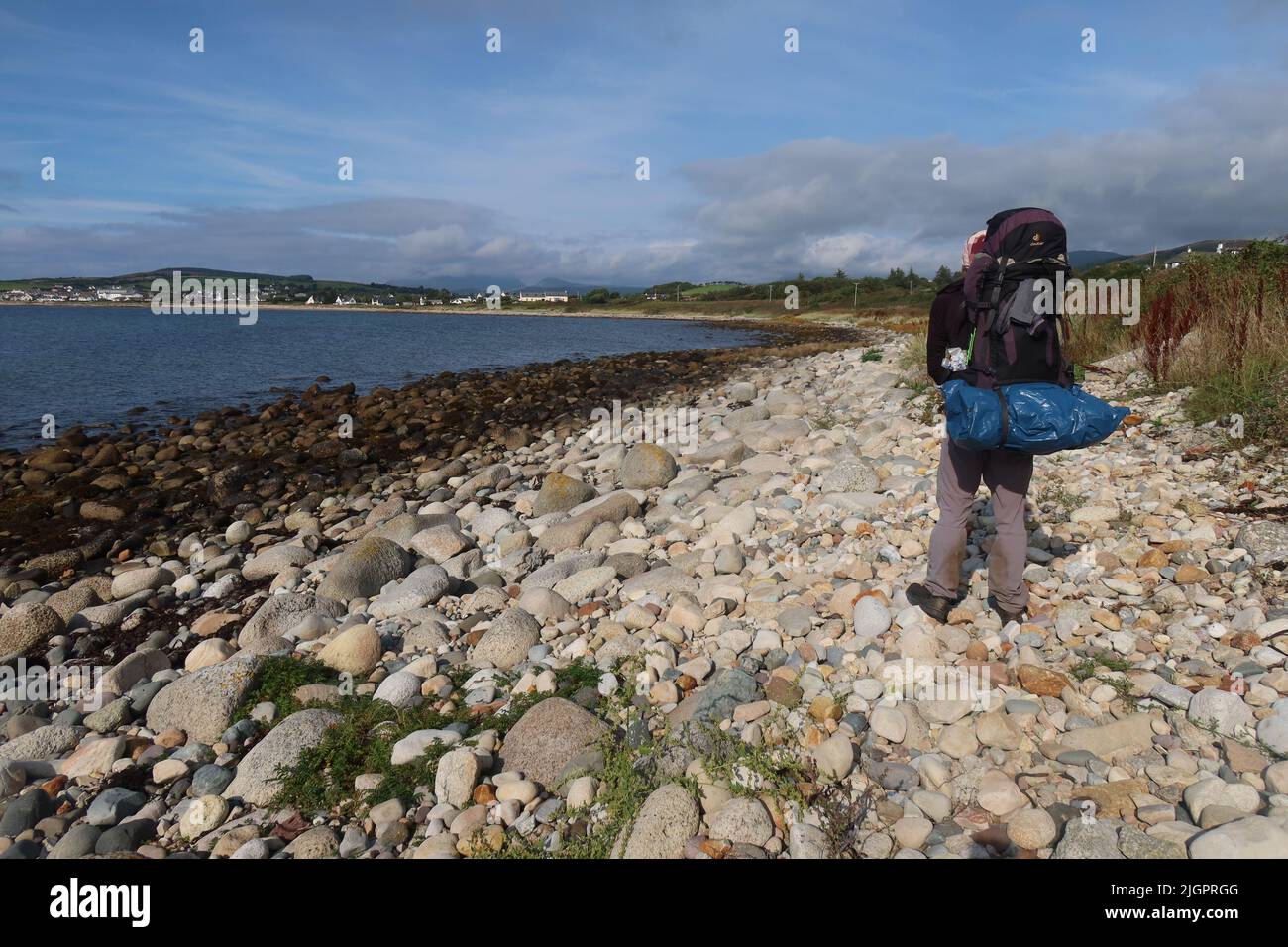 Solo Backpacker hiking with a big backpack. Arran Coastal Way. Isle of ...