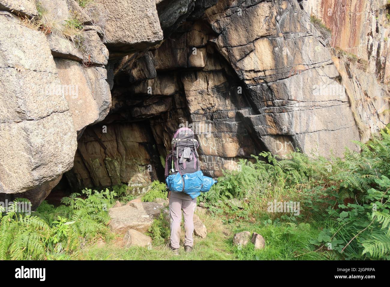 Solo Backpacker hiking with a big backpack. Arran Coastal Way. Isle of ...