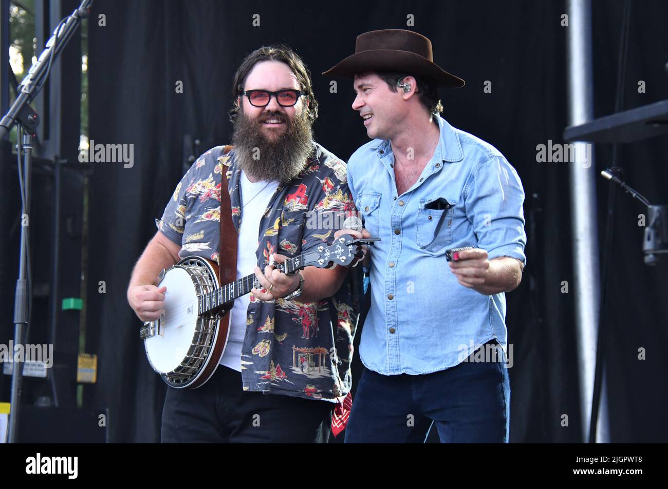 Musicians Cory Younts and Mike Harris are shown performing on stage ...