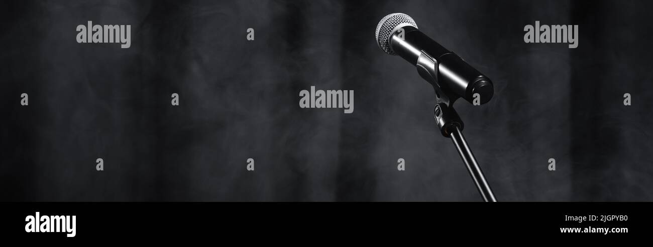 microphone on stand on black stage with curtain and smoke, banner Stock ...