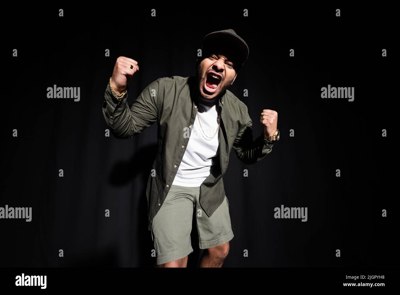 emotional and stylish indian hip hop singer in cap singing loud on ...