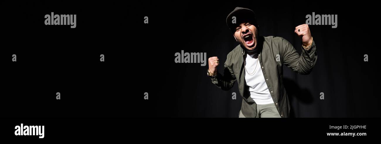 emotional and stylish indian hip hop singer in cap singing loud on ...