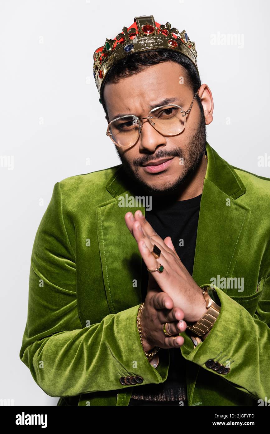 eastern hip hop performer in green velvet blazer and crown on head ...