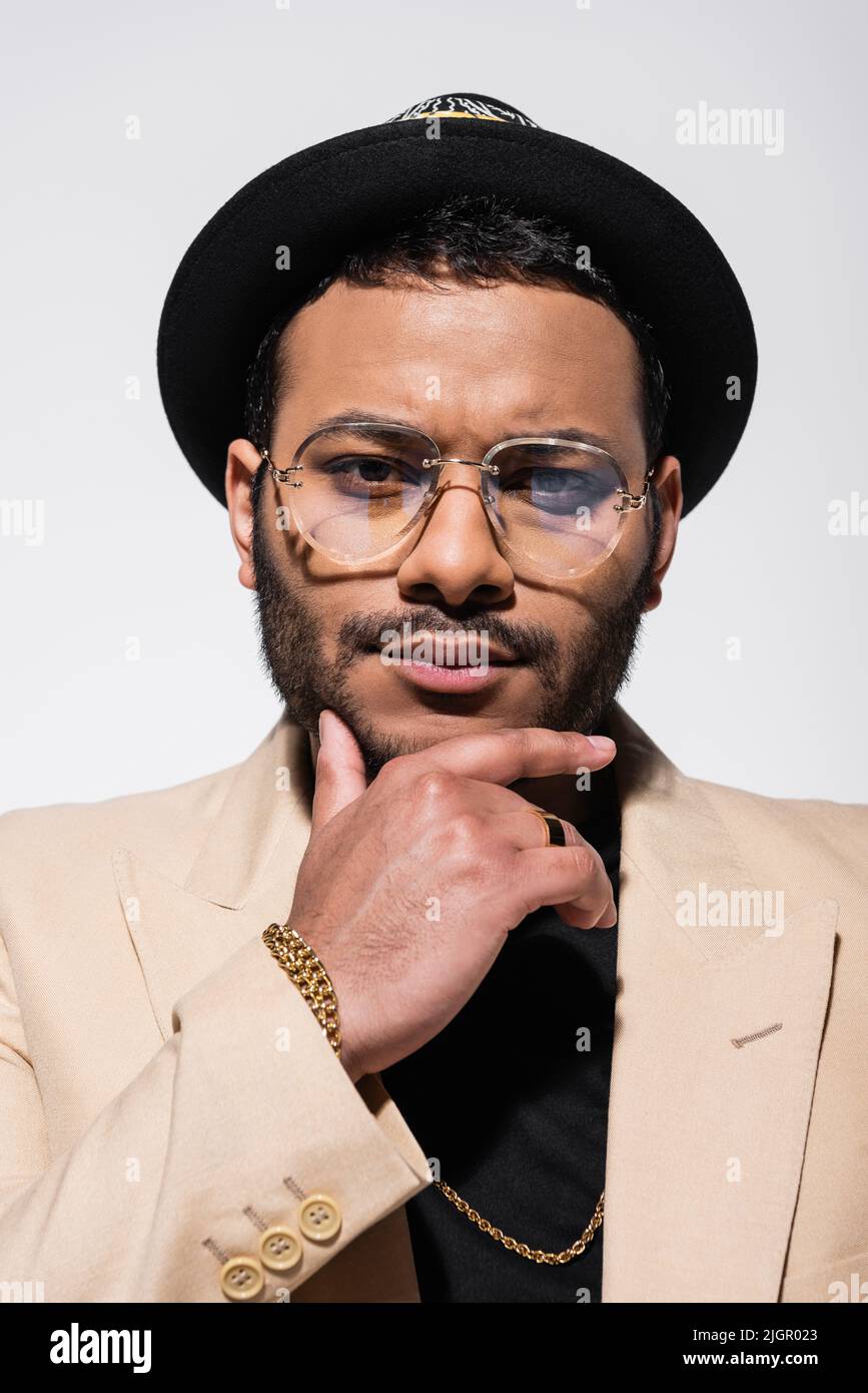 portrait of trendy indian hip hop performer in fedora hat and ...