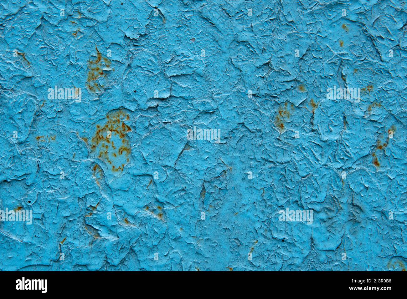 Old blue colored cracked paint. Paint applied to a rusty metal sheet ...