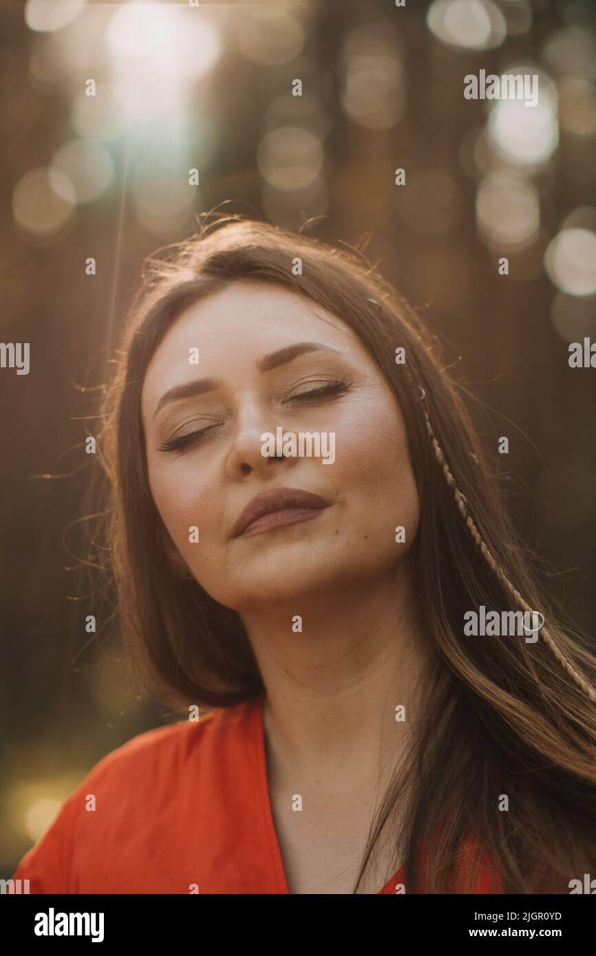 Peace of mind, breathing fresh air. Alone woman in red dress enjoys the ...