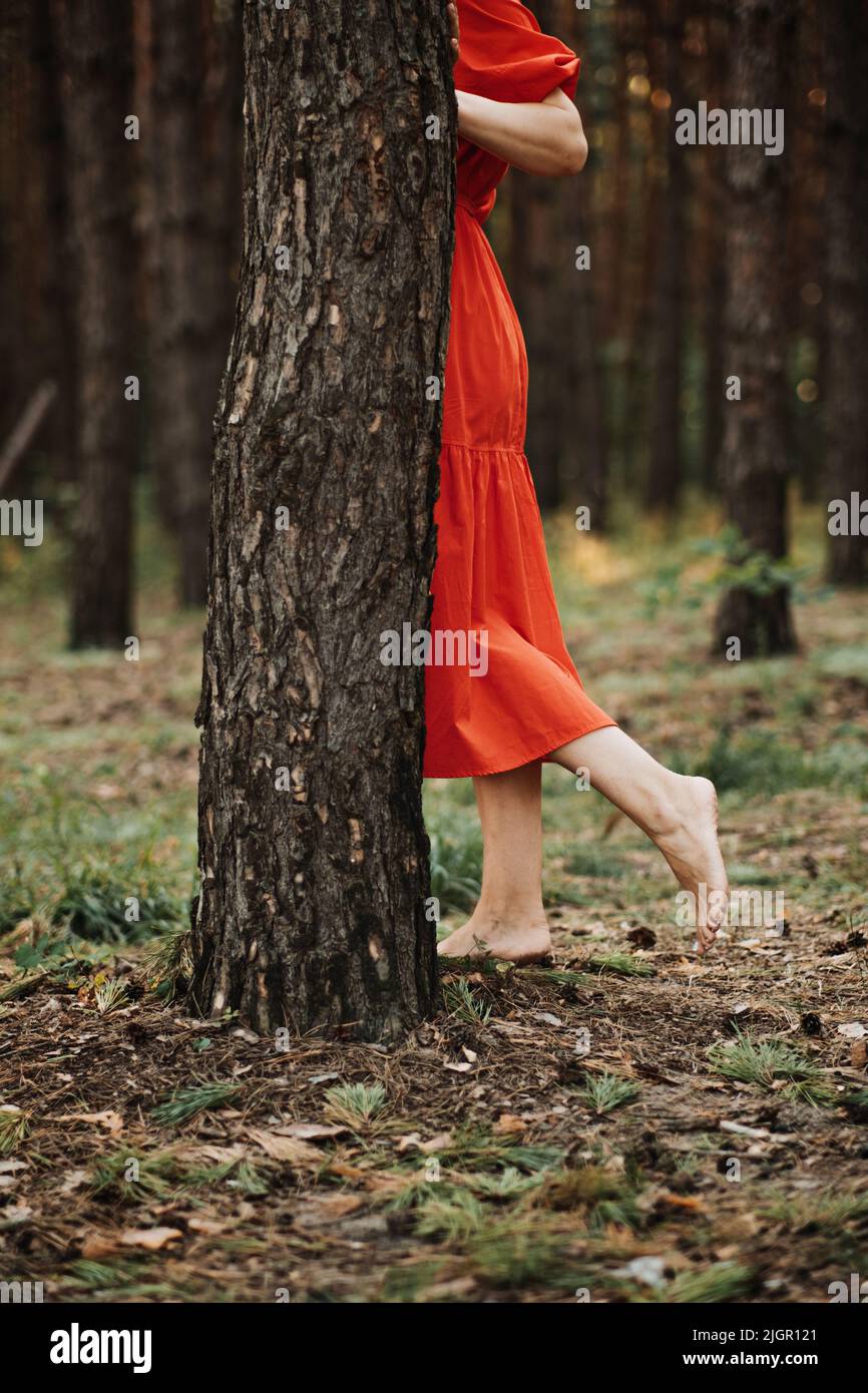 Peace of mind, breathing fresh air. Alone woman in red dress enjoys the ...