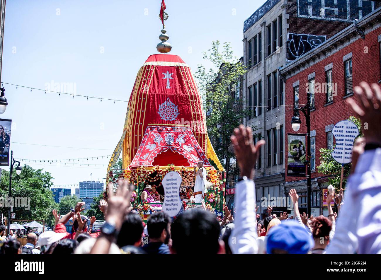 Montreal, Canada. 09th July, 2022. Devotees raise their arms to welcome ...