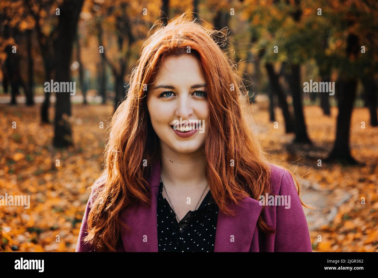 Autumn Portrait Of Candid Beautiful Red Haired Girl With Fall Leaves In