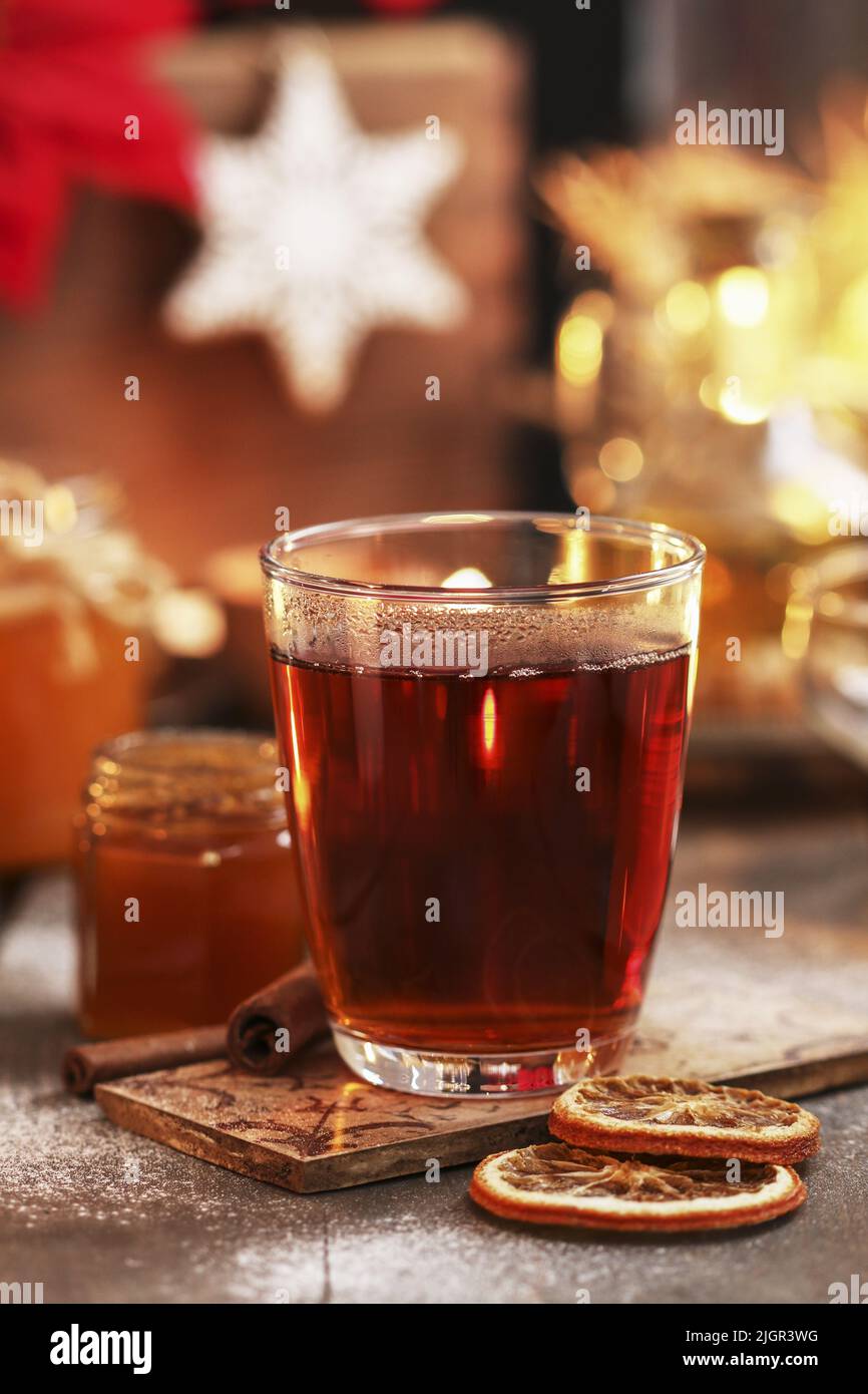 Glass of Christmas tea with cloves and cinnamon. Festive time Stock ...