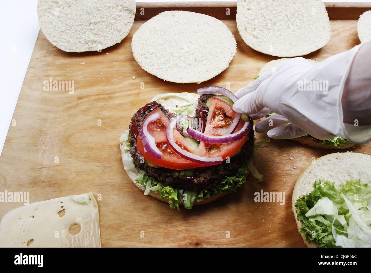 The chef prepares a burger in a restaurant. Cooking time Stock Photo ...