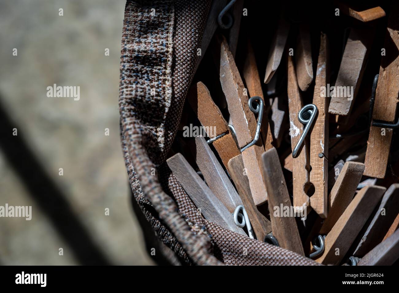 assorted pile of old cloths pins in a bag used for hanging wet laundry ...