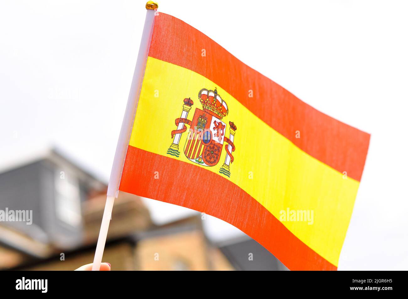 close up of National Spanish flag yellow and red colors,hand holding ...