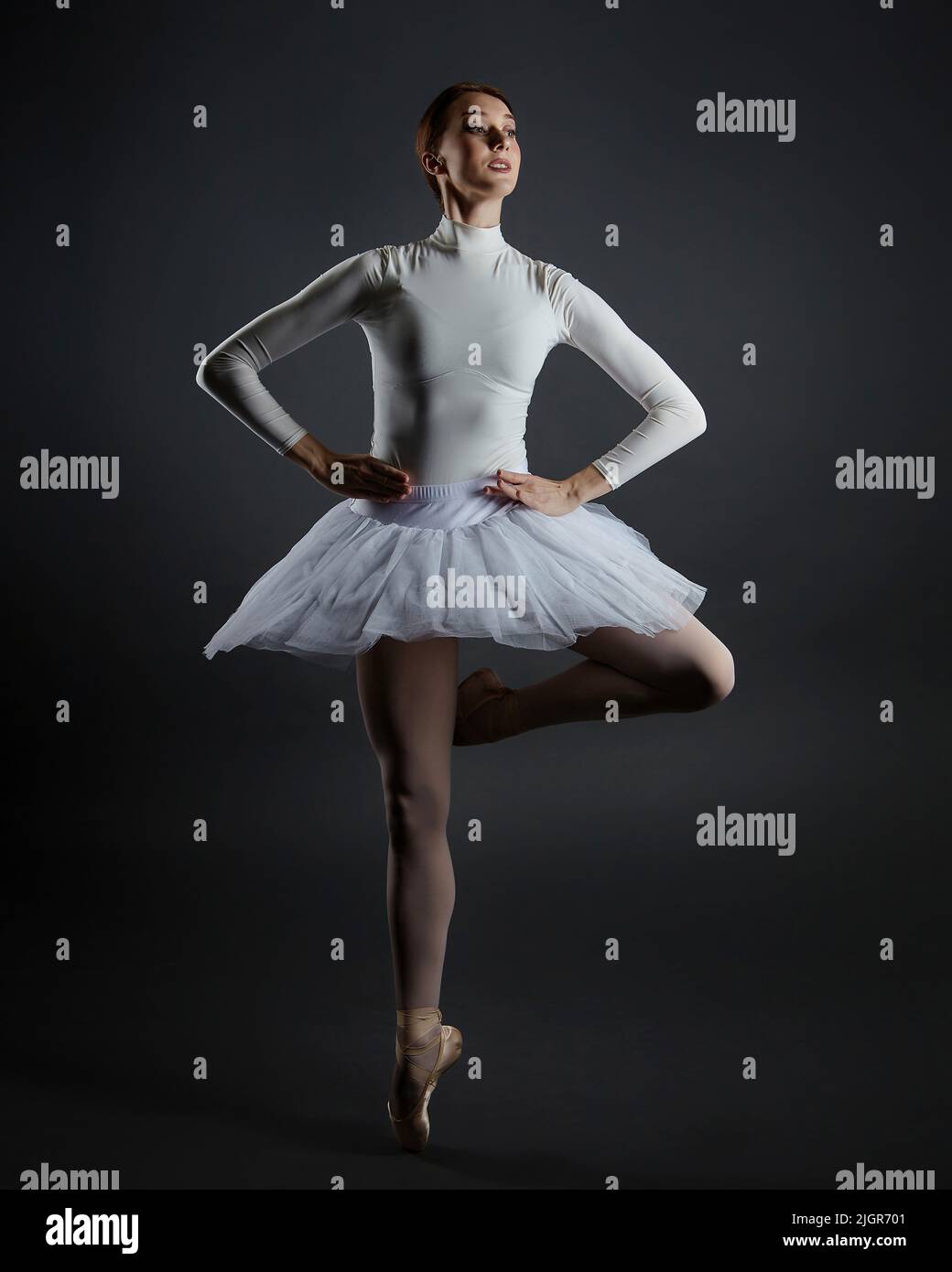 attractive ballerina stands on her fingertips. photo shoot in the ...