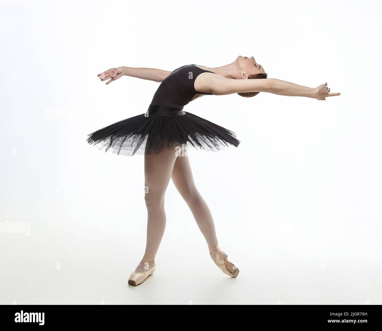 attractive ballerina stands on her fingertips. photo shoot in the ...