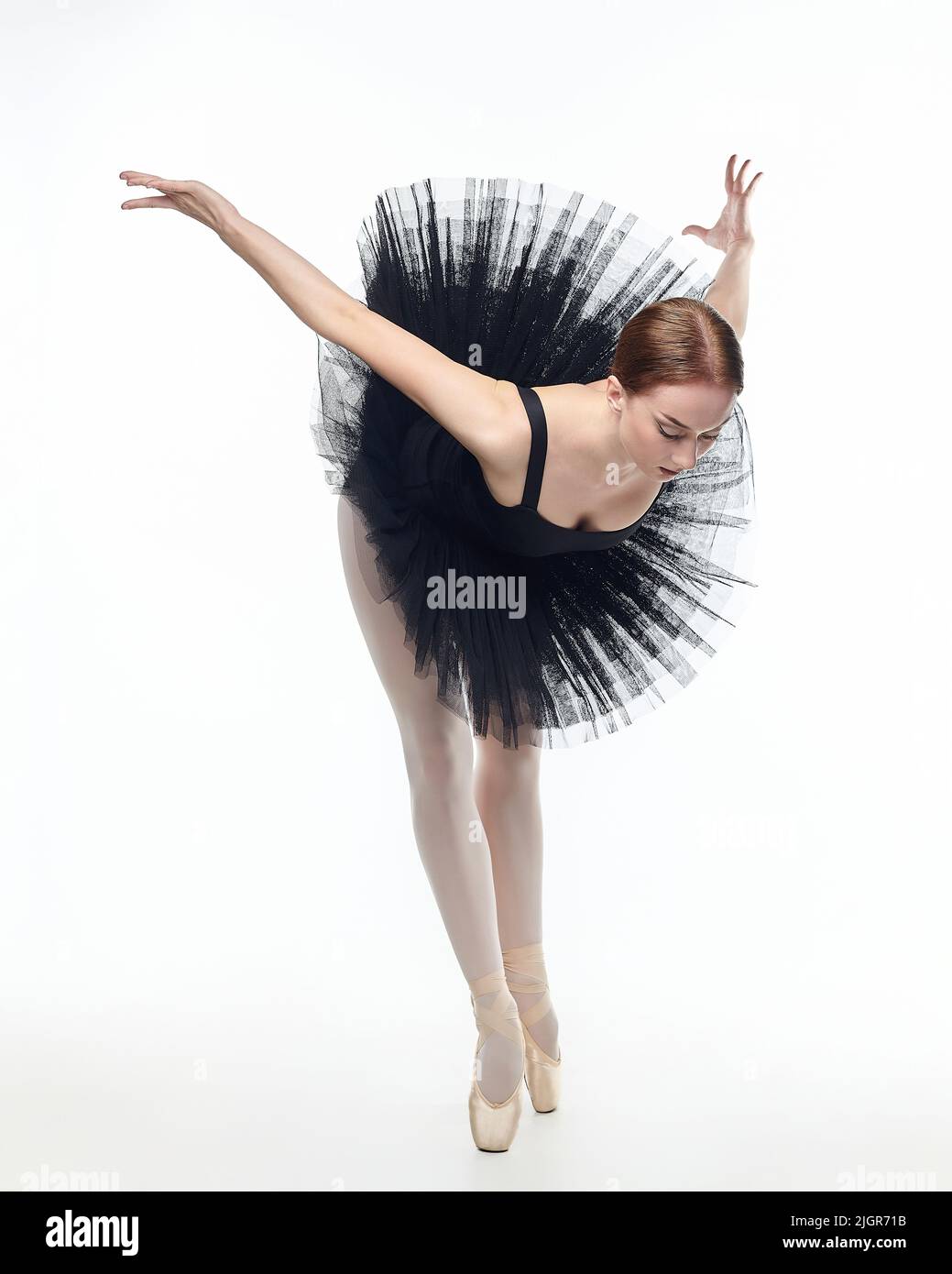 attractive ballerina stands on her fingertips. photo shoot in the ...