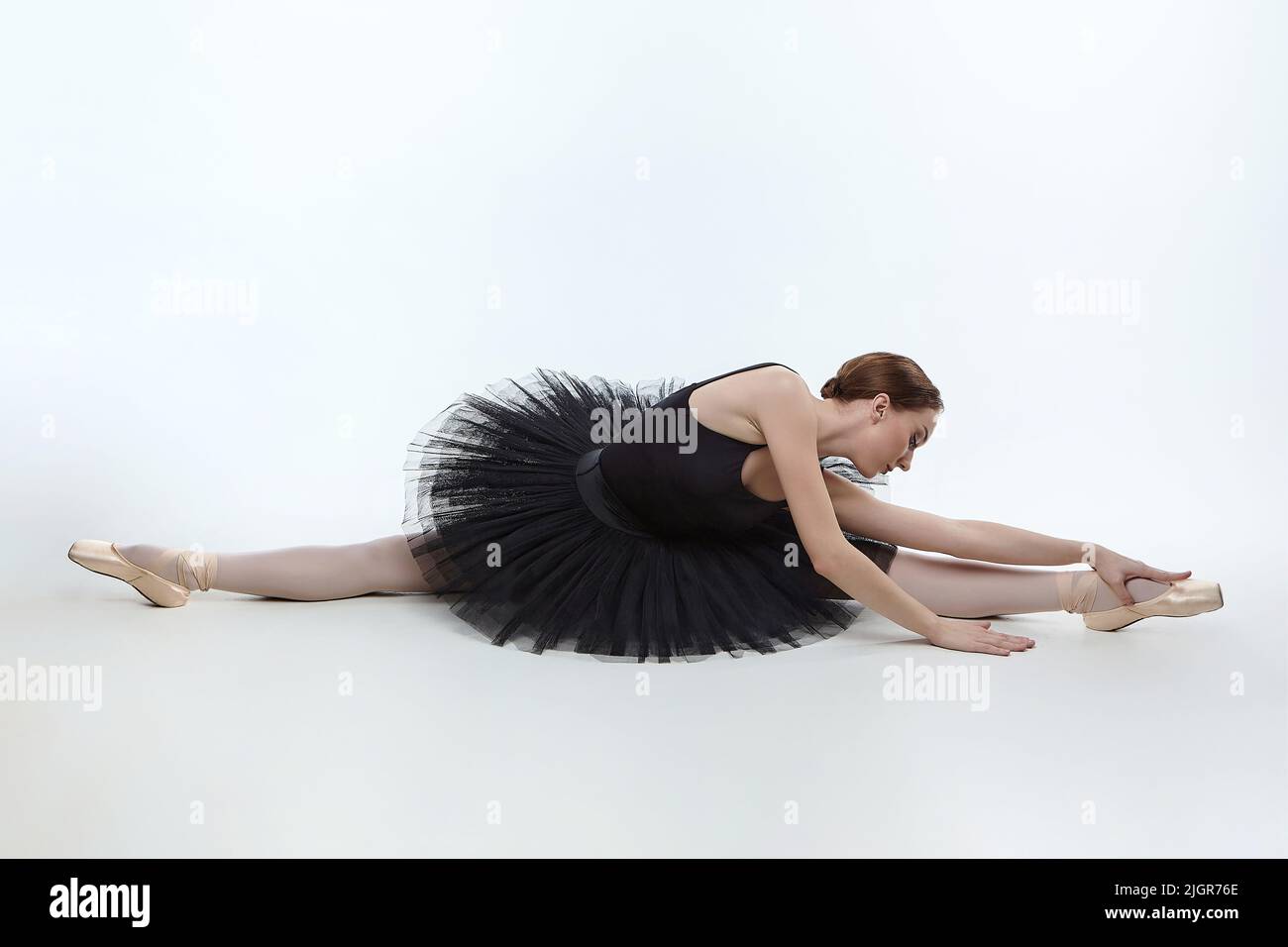 elegant ballerina did a stretch. photo shoots in the studio on a white ...