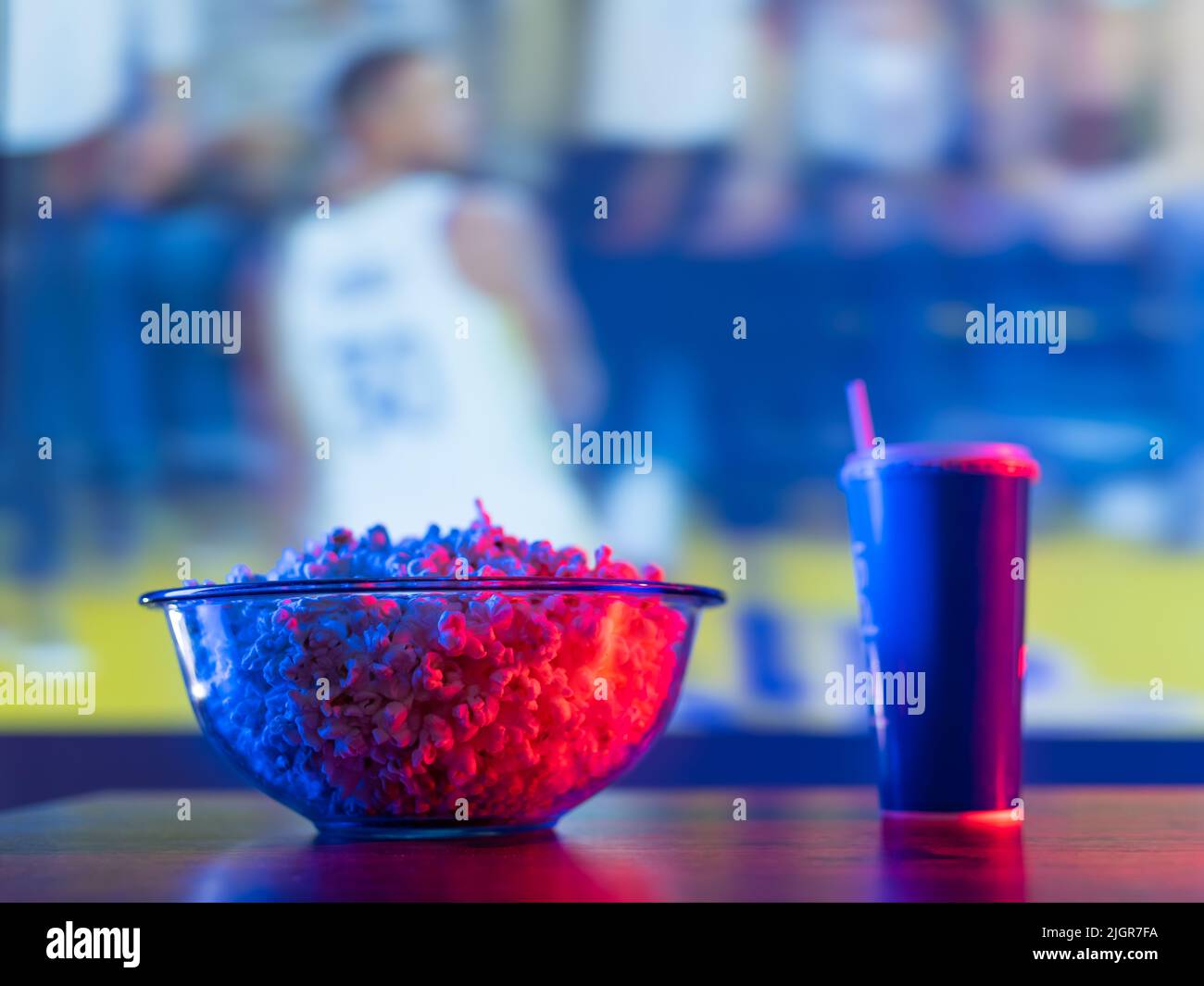 Fast food - popcorn in a glass bowl and a soda drink in a plastic glass ...