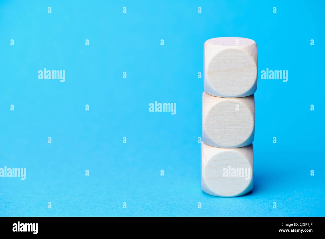 stack of three wooden cubes against blue background Stock Photo - Alamy