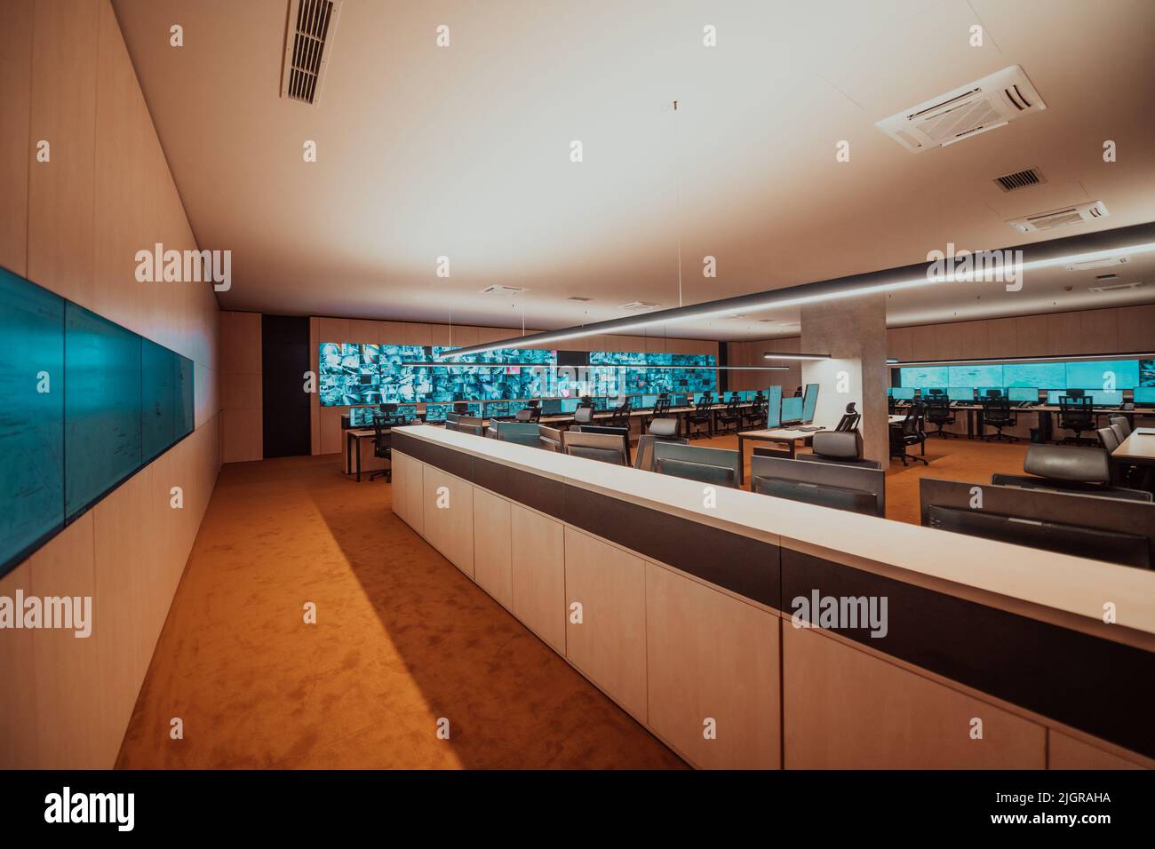 Empty interior of big modern security system control room, workstation ...