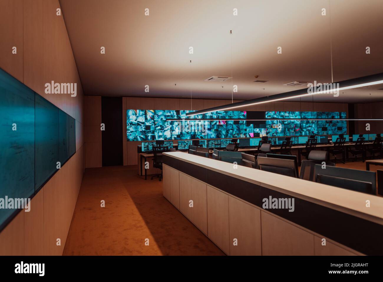 Empty interior of big modern security system control room, workstation ...