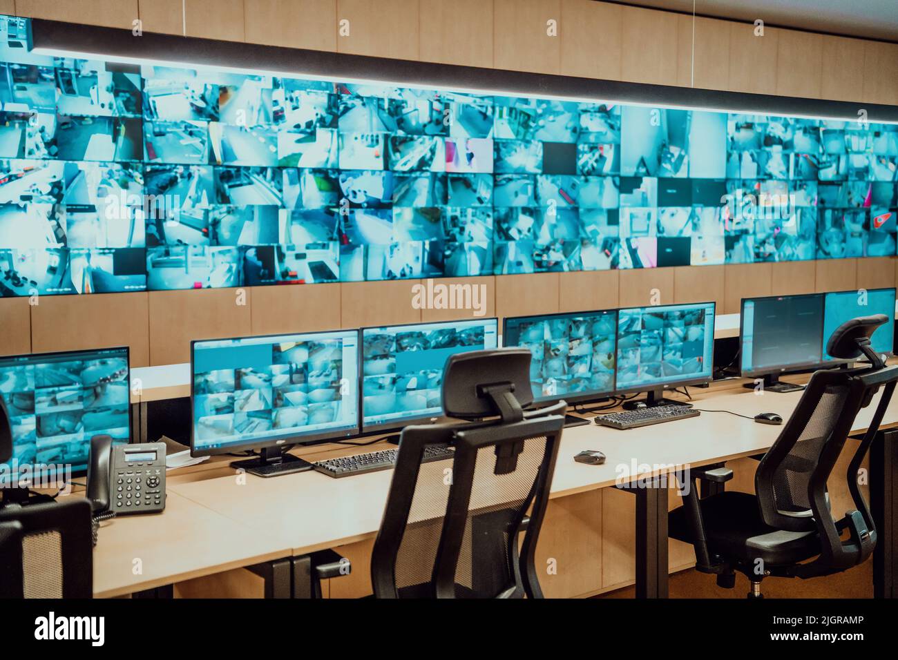 Empty interior of big modern security system control room, workstation ...