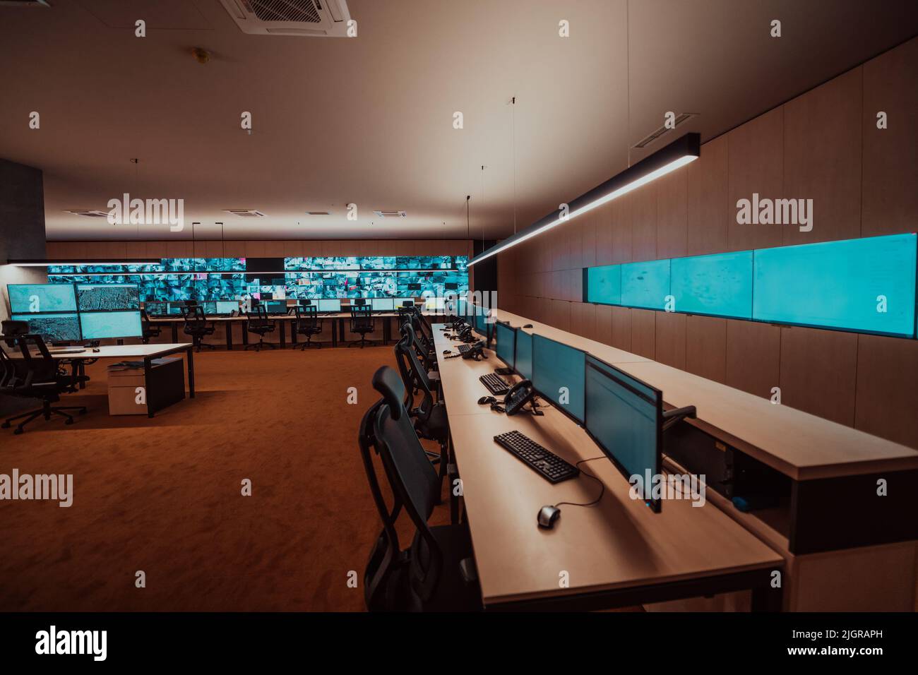 Empty interior of big modern security system control room, workstation ...