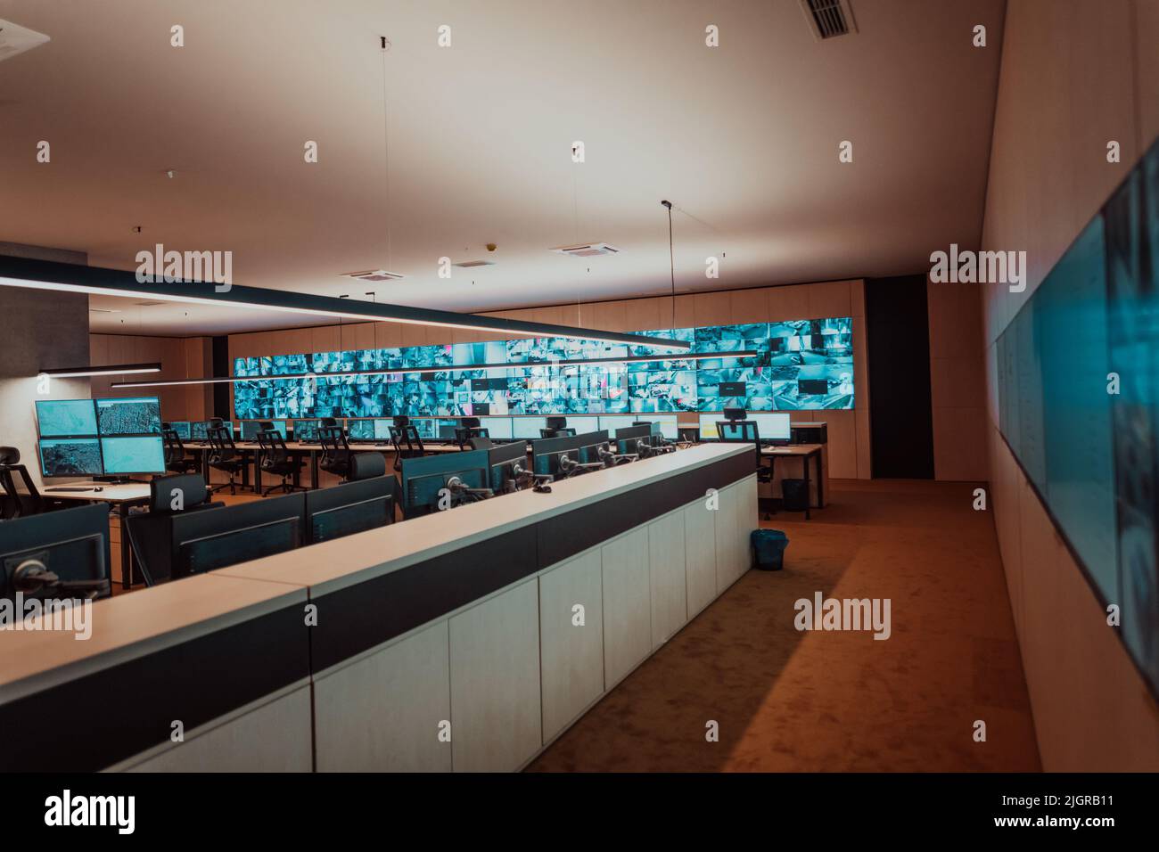 Empty interior of big modern security system control room, workstation ...