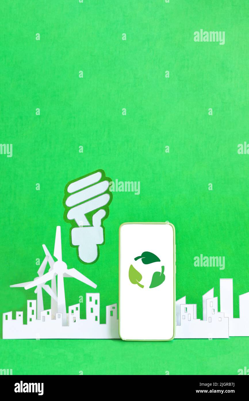 A green poster with a white windmill, lightbulb a recycling symbol ...