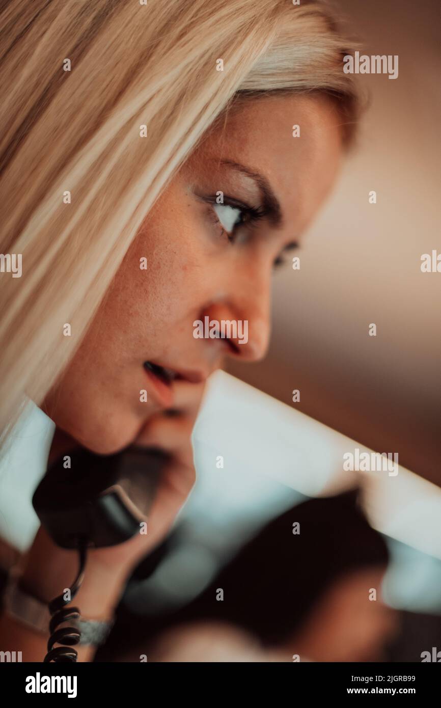 Female security guard operator talking on the phone while working at ...