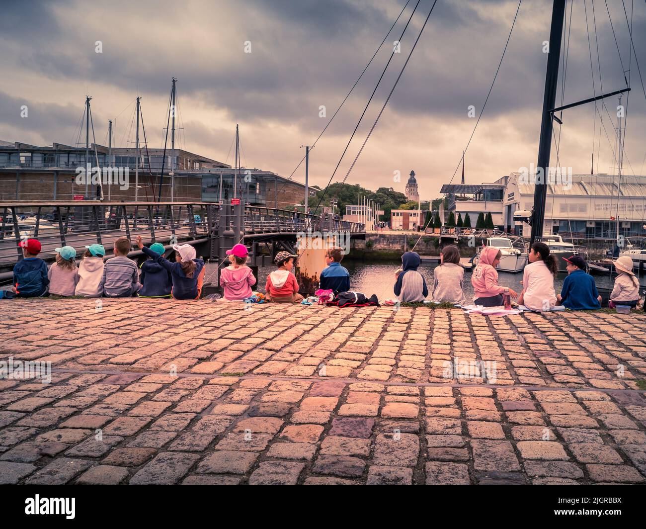 La rochelle, France, July 2022. A group of children sitting backwards ...