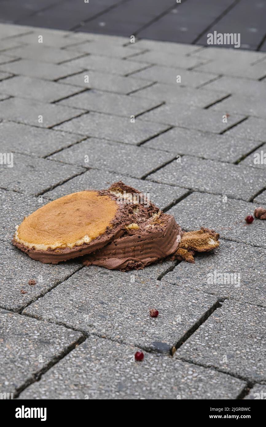 A vertical shot of a damaged cake in the middle of a street Stock Photo ...