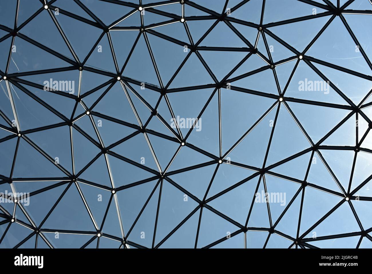 A spherical architectural structure assembled from rods forming a ...