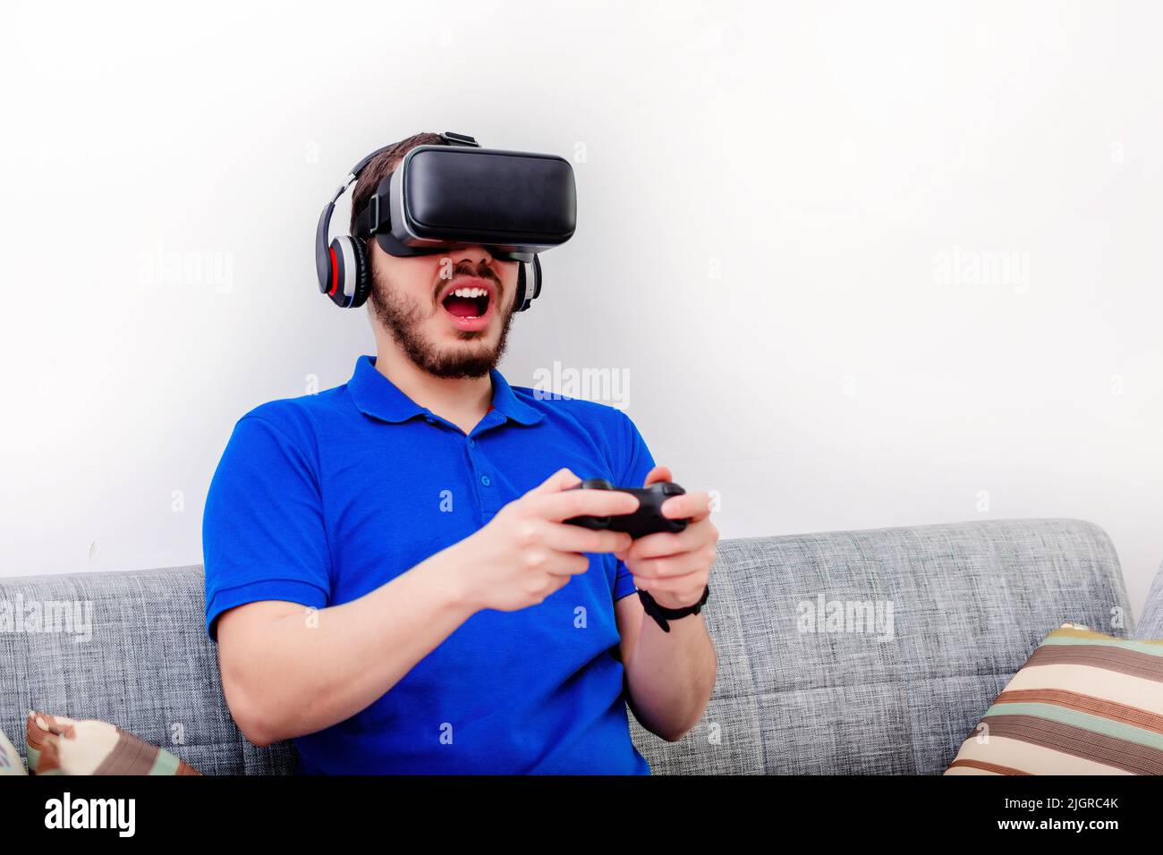 A view of a male playing game using a virtual reality headset and ...