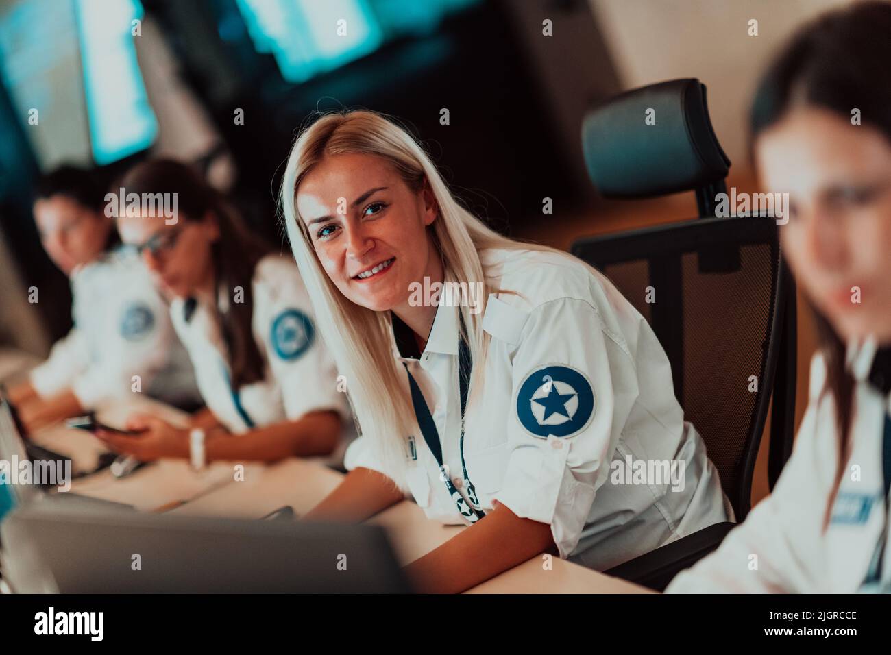 Female security operator working in a data system control room offices ...
