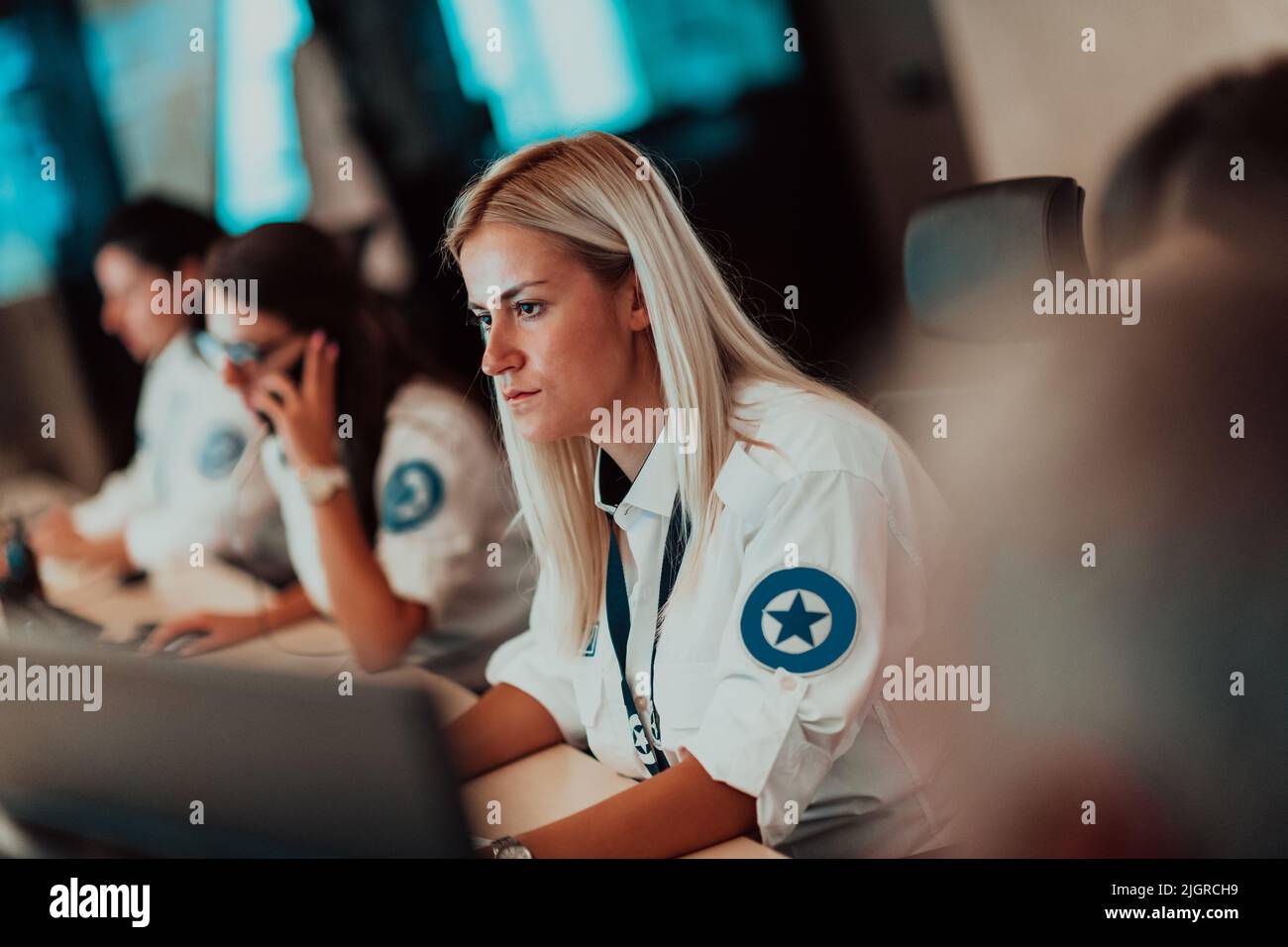 Female security operator working in a data system control room offices ...