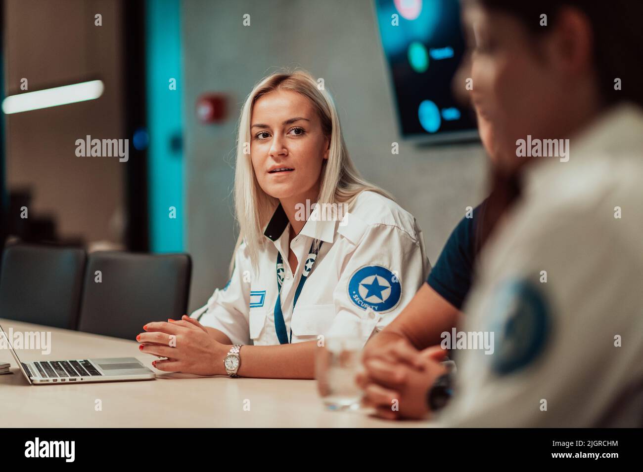 Group of female security operators working in a data system control ...
